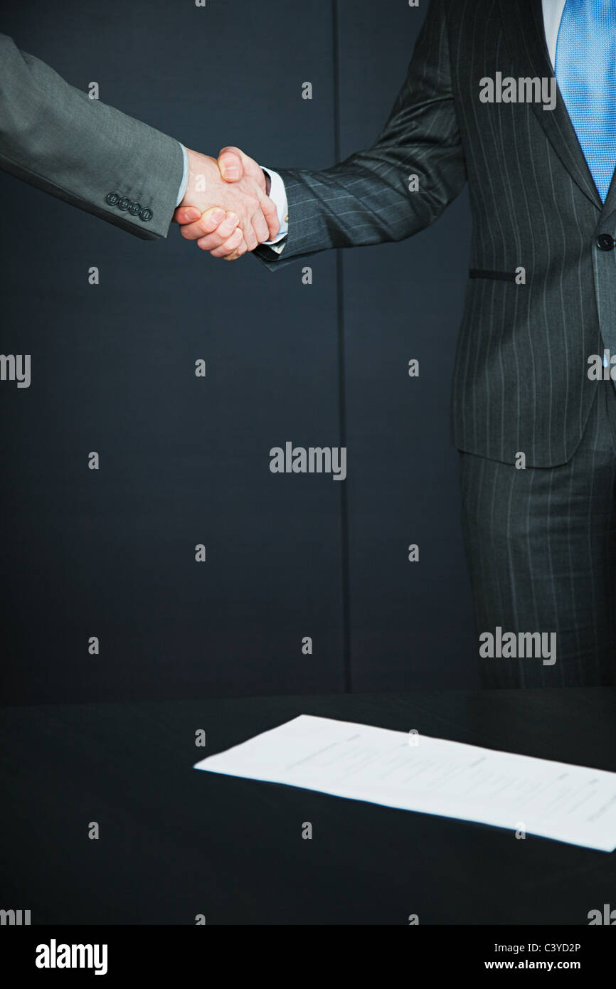 Two businessmen shaking hands at job interview Stock Photo - Alamy