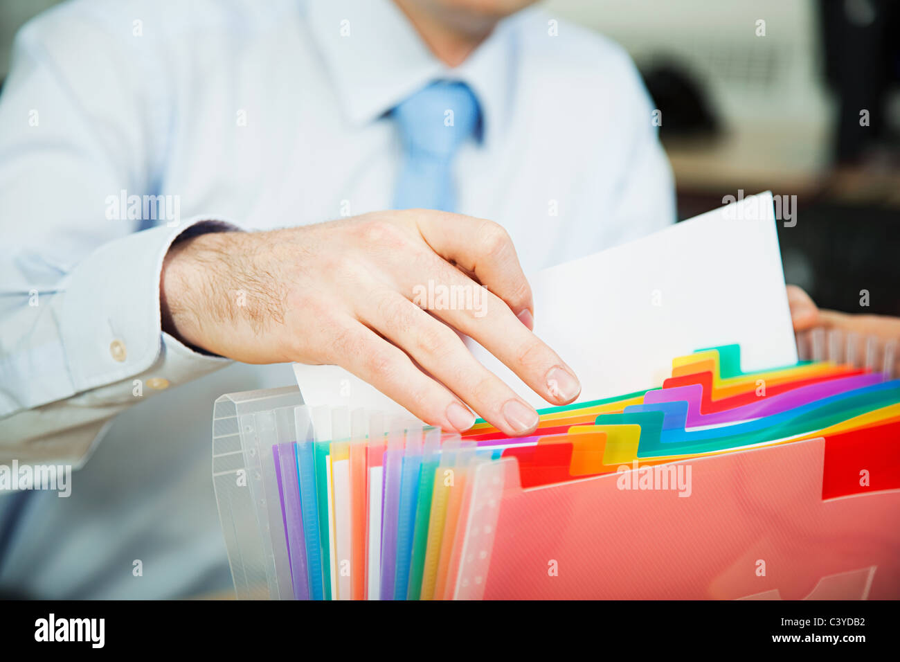 Office worker filing document Stock Photo - Alamy