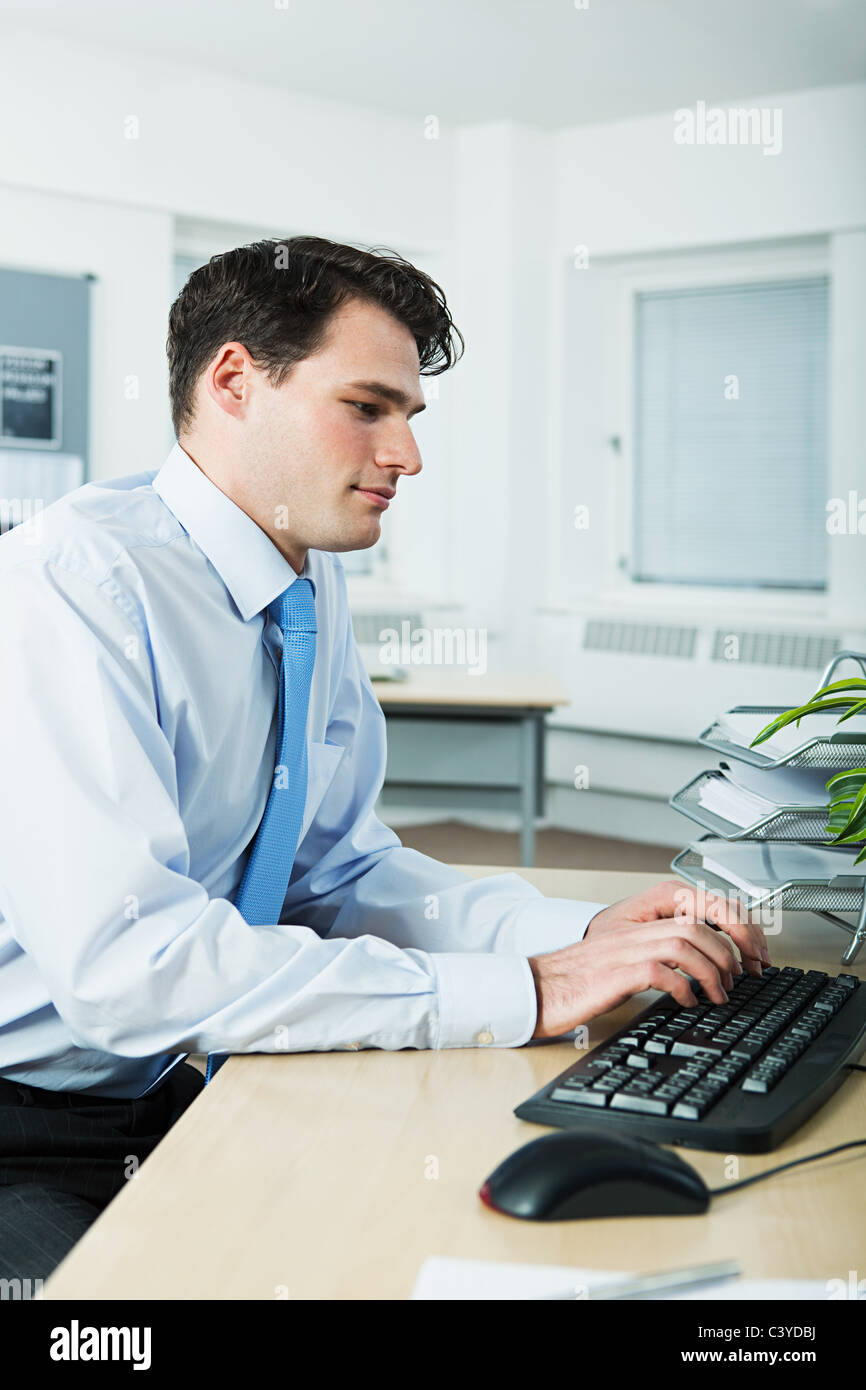 Office worker using computer Stock Photo - Alamy
