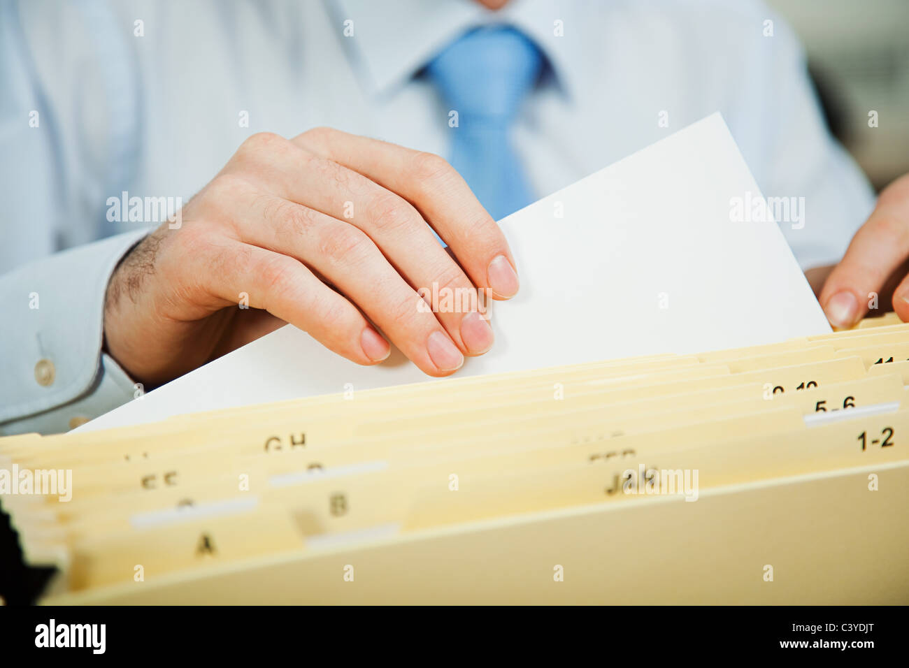 Office worker filing document Stock Photo - Alamy
