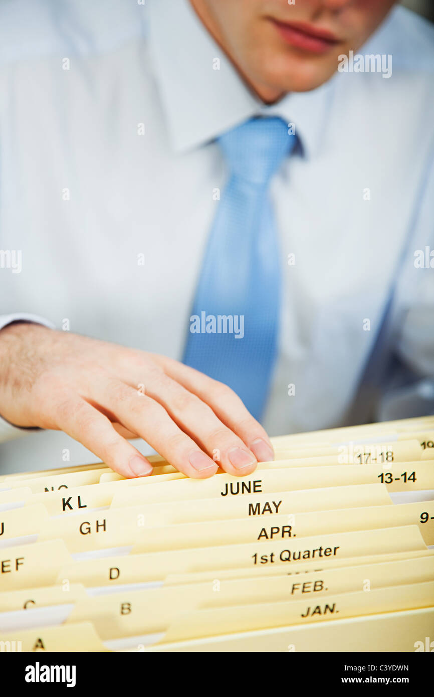 Office worker filing document Stock Photo - Alamy