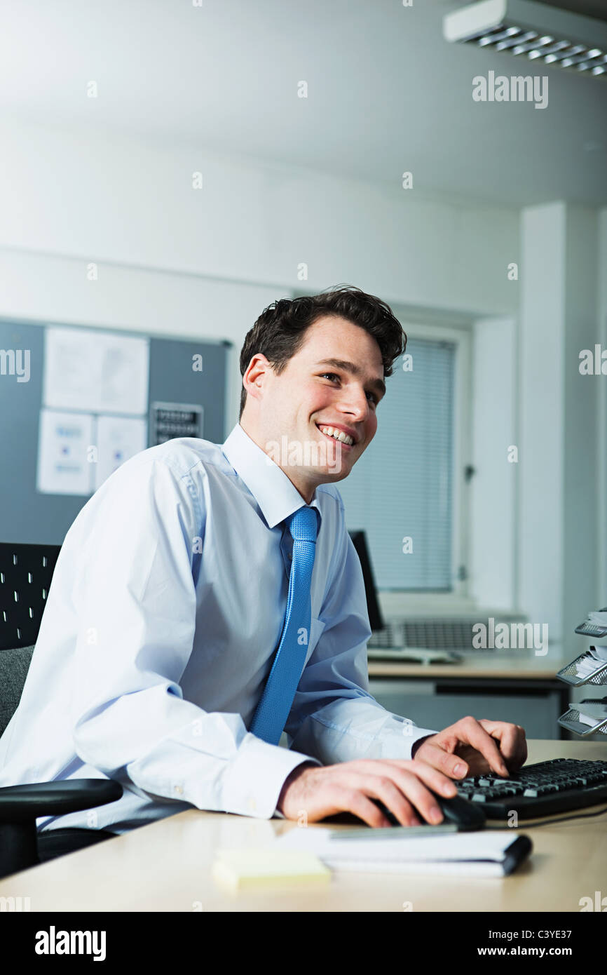 Office worker using computer Stock Photo - Alamy