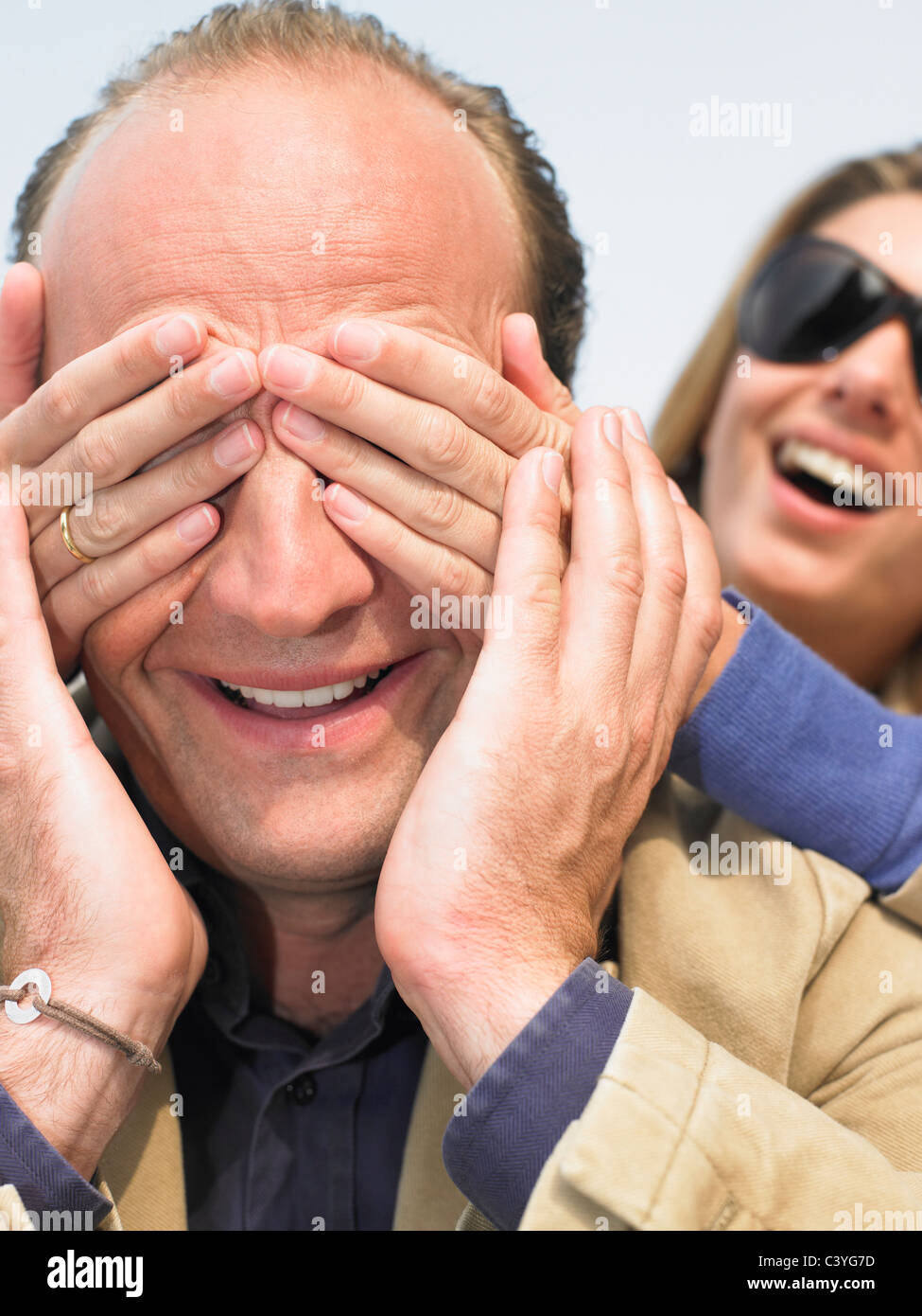 Woman hiding man's face with her hands Stock Photo - Alamy