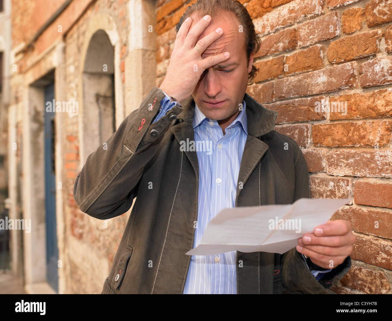 Man reading a letter Stock Photo - Alamy