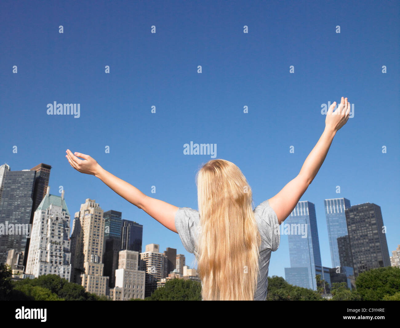 Woman spreading her arms in central park Stock Photo - Alamy