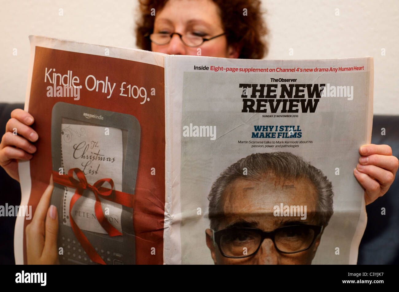 Woman reading The Observer newspaper New Review Stock Photo - Alamy