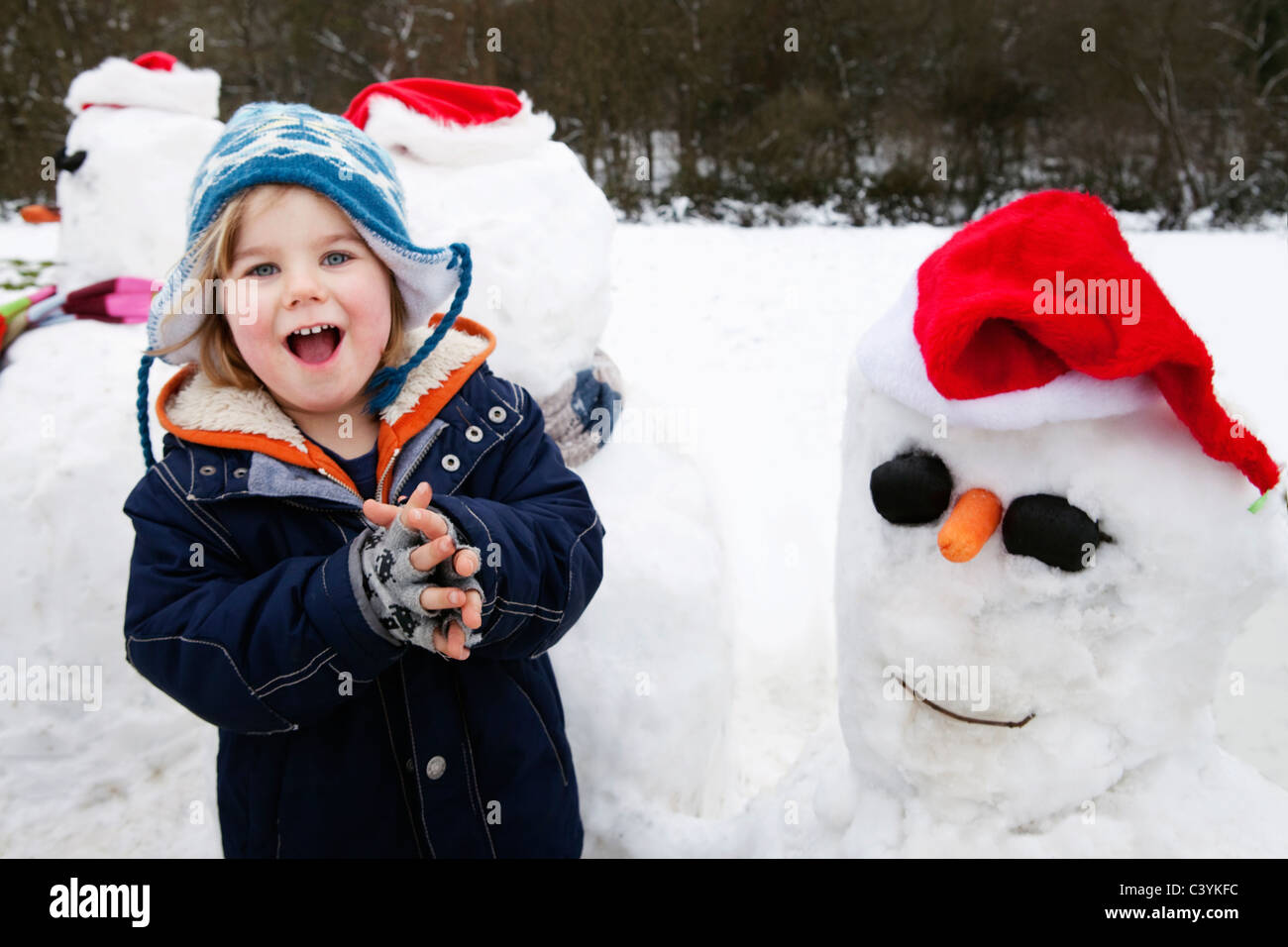 Portrait of a boy and some snowmen Stock Photo - Alamy