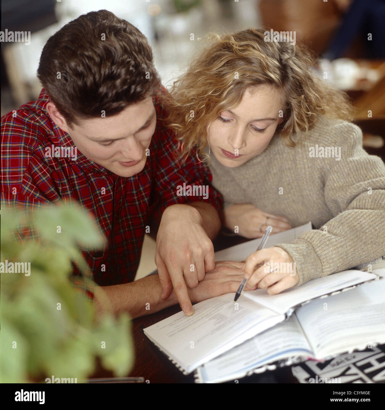 Teenage Couple Doing Homework In High Resolution Stock Photography and ...