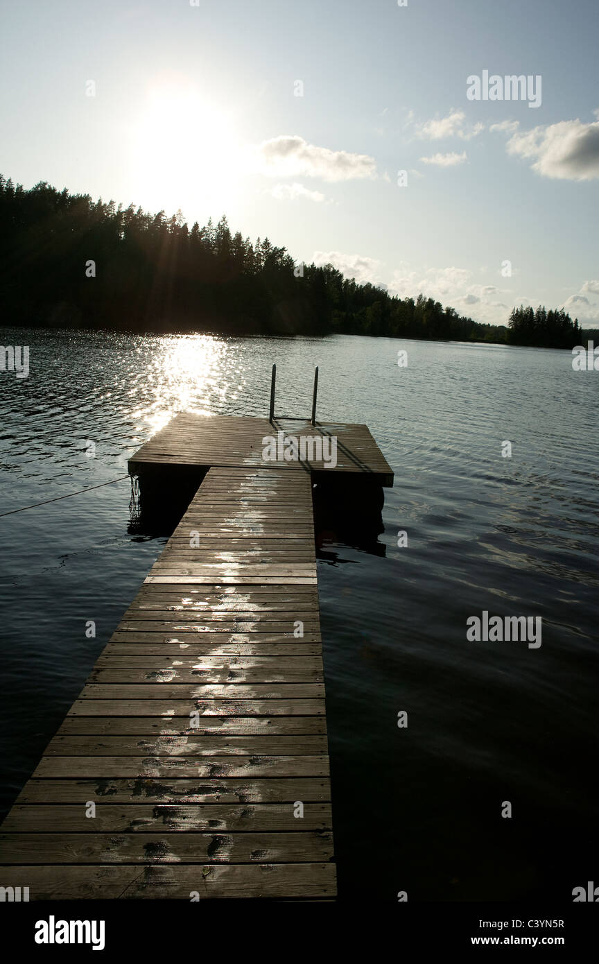 lake pier sun facing camera sunset Stock Photo - Alamy