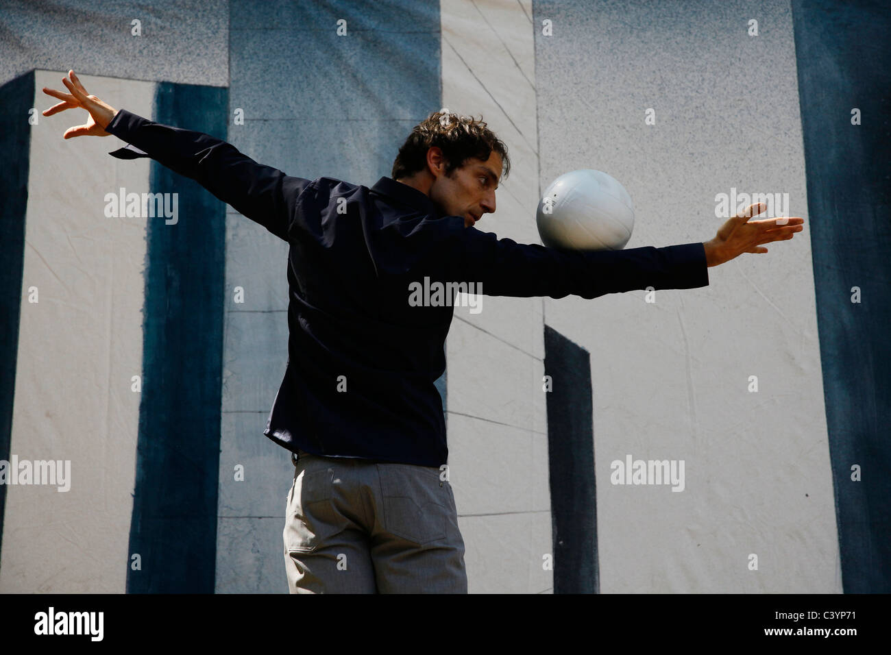 Juggler playing with a ball Stock Photo - Alamy