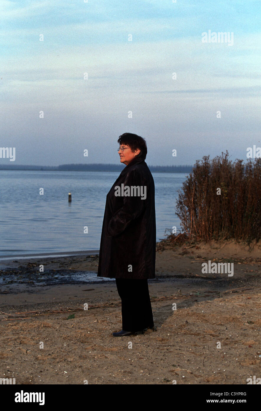 Old woman contemplating outside Stock Photo - Alamy