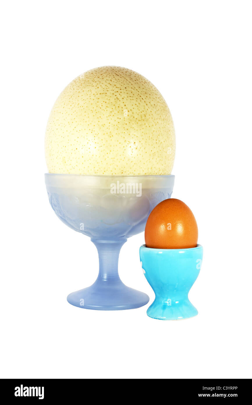 One big and one small egg on the pedestal isolated on the white Stock ...