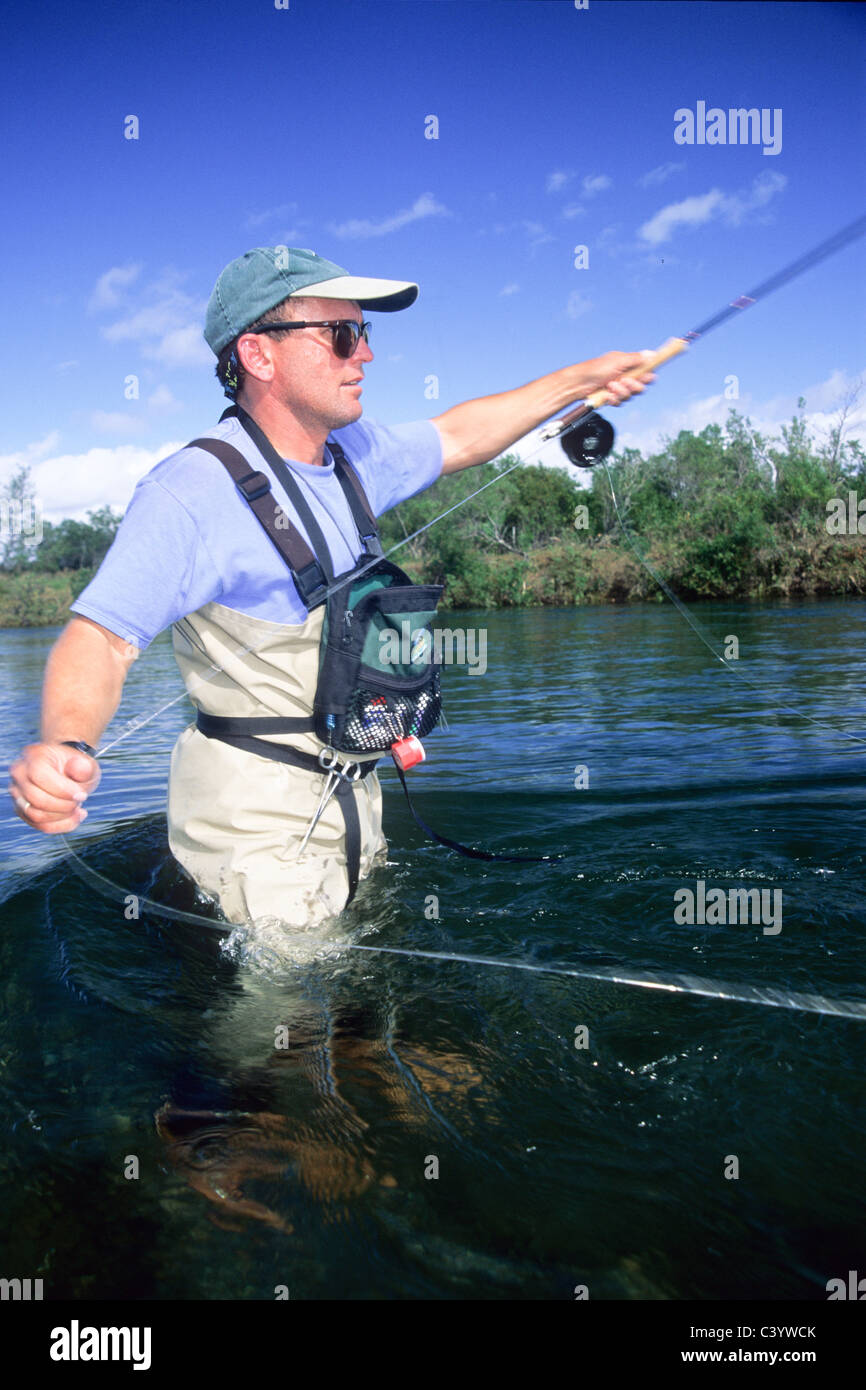 Man fly fishing at Kirman Lake in the Sierra Nevadas in a float tube ...