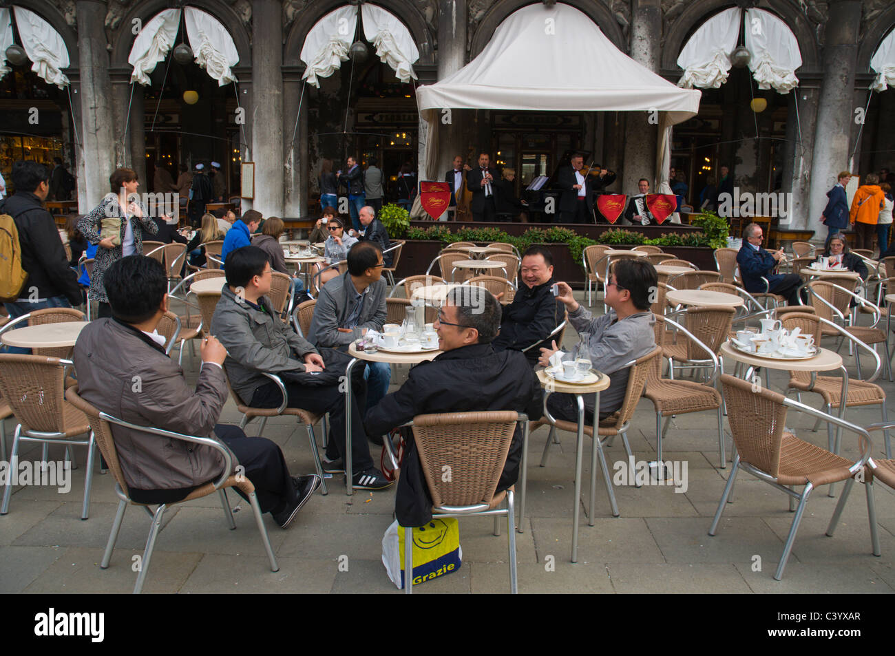 Group of Asian males enjoying coffee and music at Cafe Florian at St ...