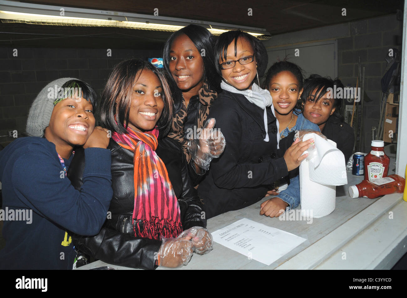 Teenage concession stand workers pose for a picture during a high ...
