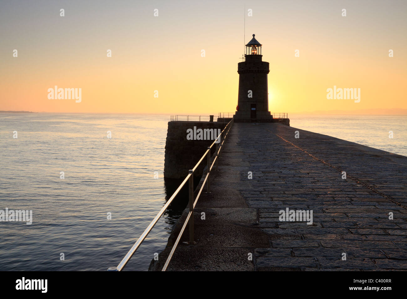 St Peters Port lighthouse at sunrise Stock Photo - Alamy