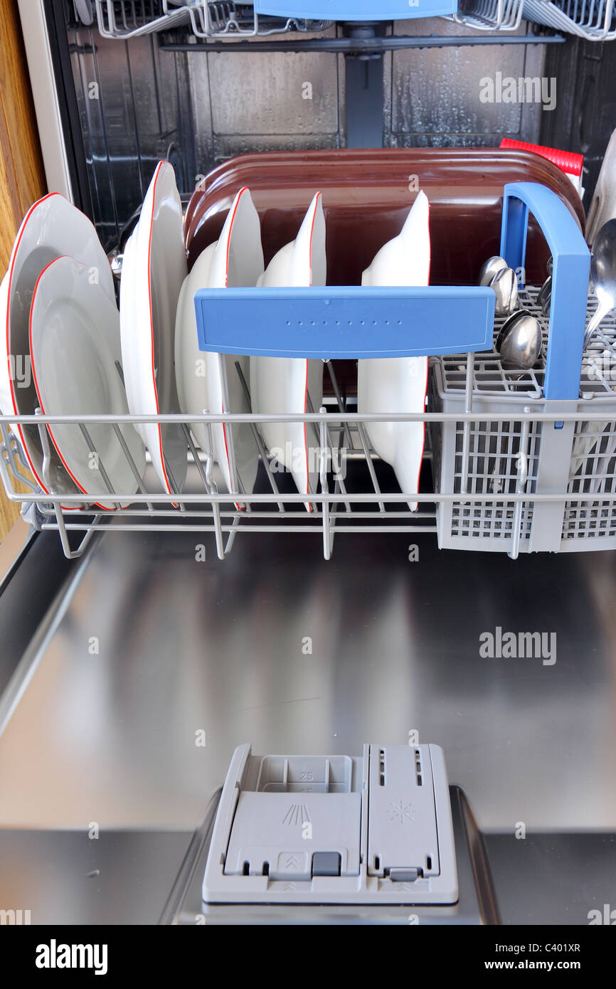 open dishwasher with clean dishes in kitchen Stock Photo - Alamy