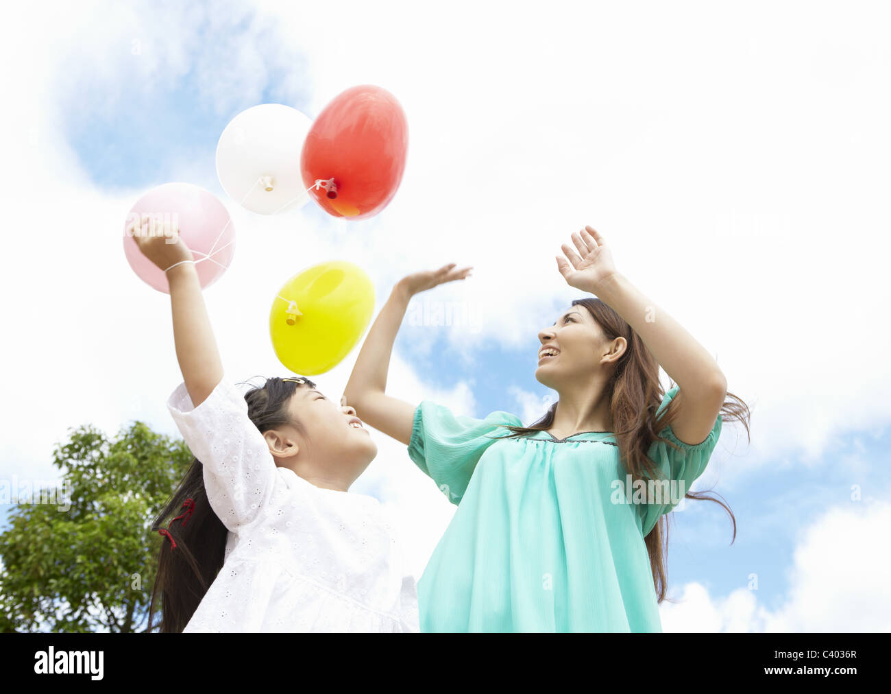 Mother and child playing with balloons Stock Photo - Alamy