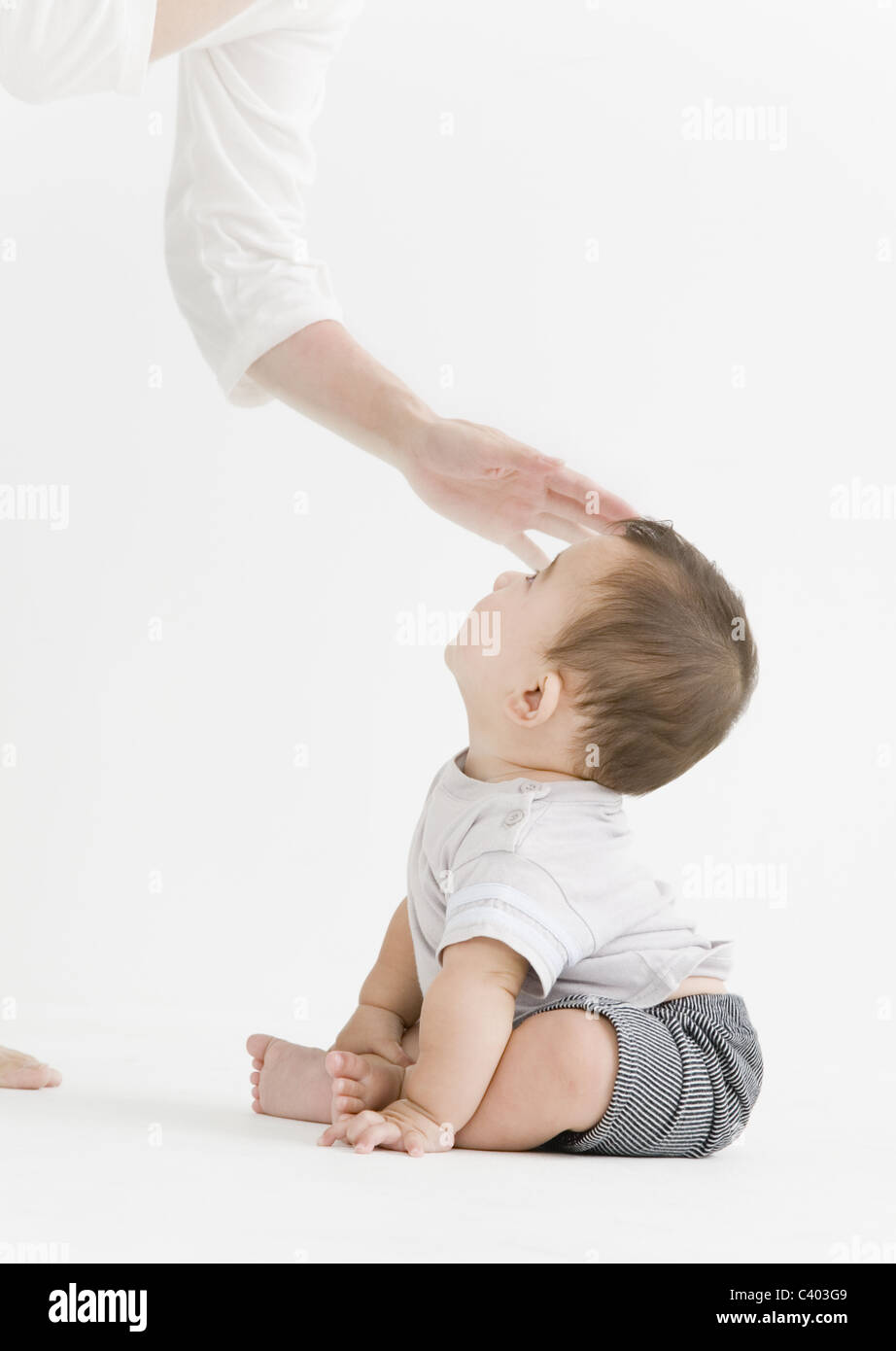 Hand caressing baby Stock Photo - Alamy