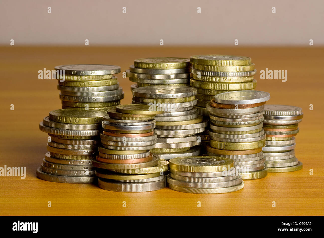Stacks of coins placed on top of a table Stock Photo - Alamy