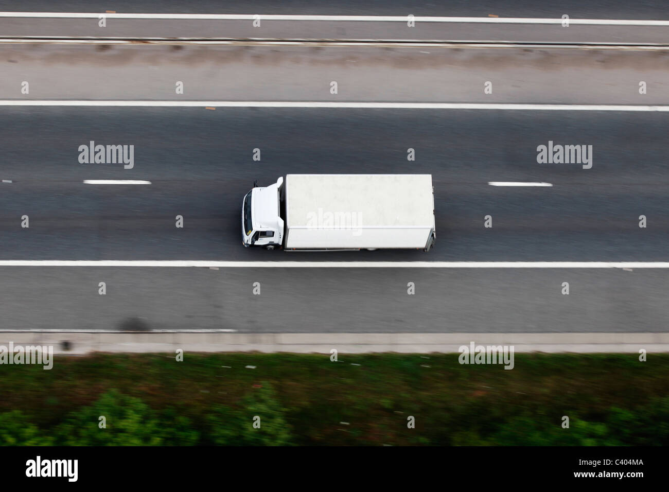 Aerial shot of a white lorry driving on a dual carriageway in Bristol ...