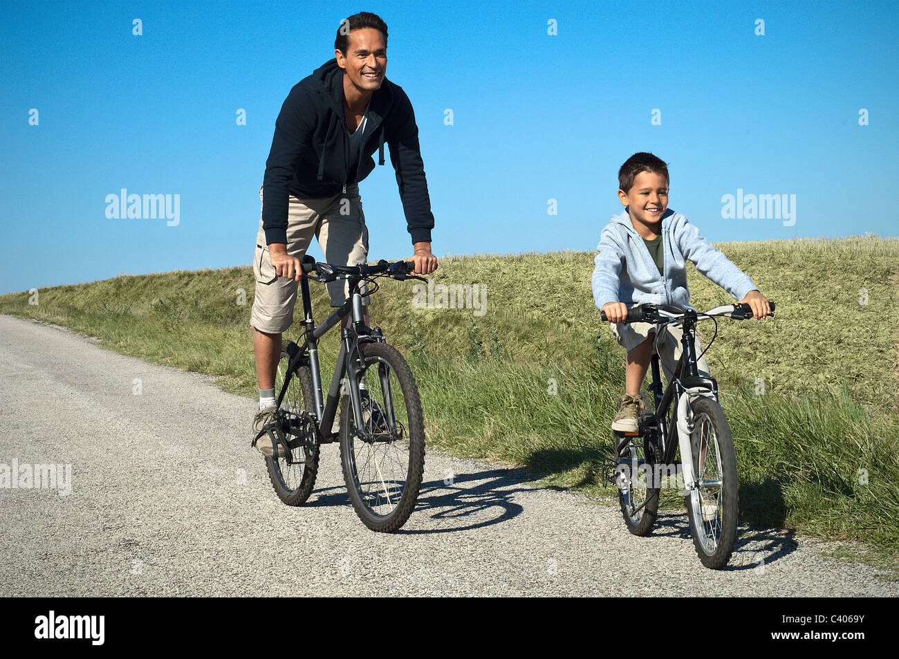Father and son cycling Stock Photo - Alamy