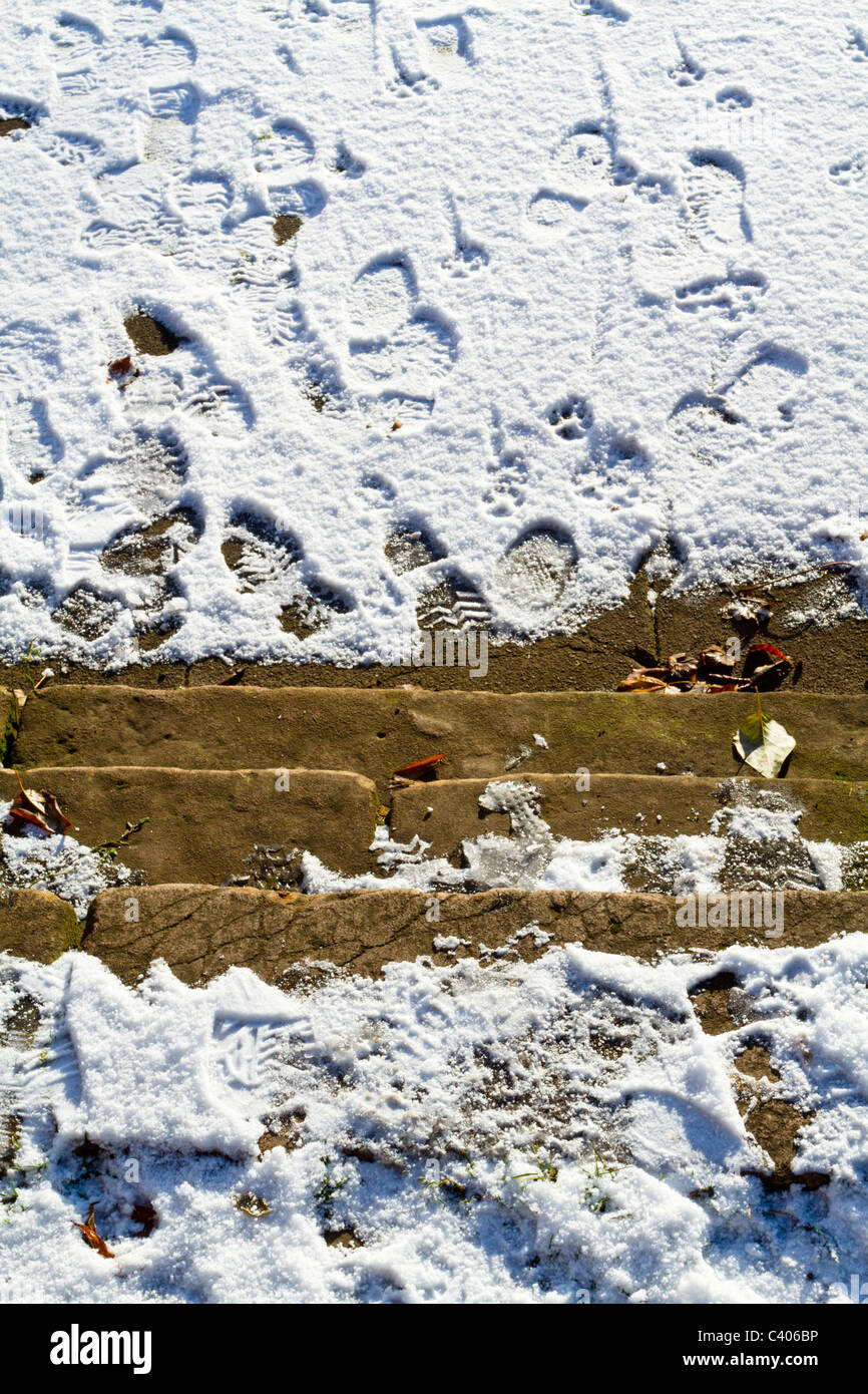 Stone steps with footprints in snow Stock Photo - Alamy