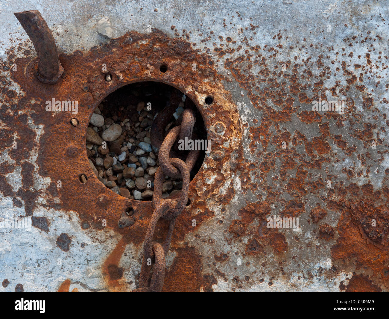 chain passing through a rusty hole Stock Photo - Alamy