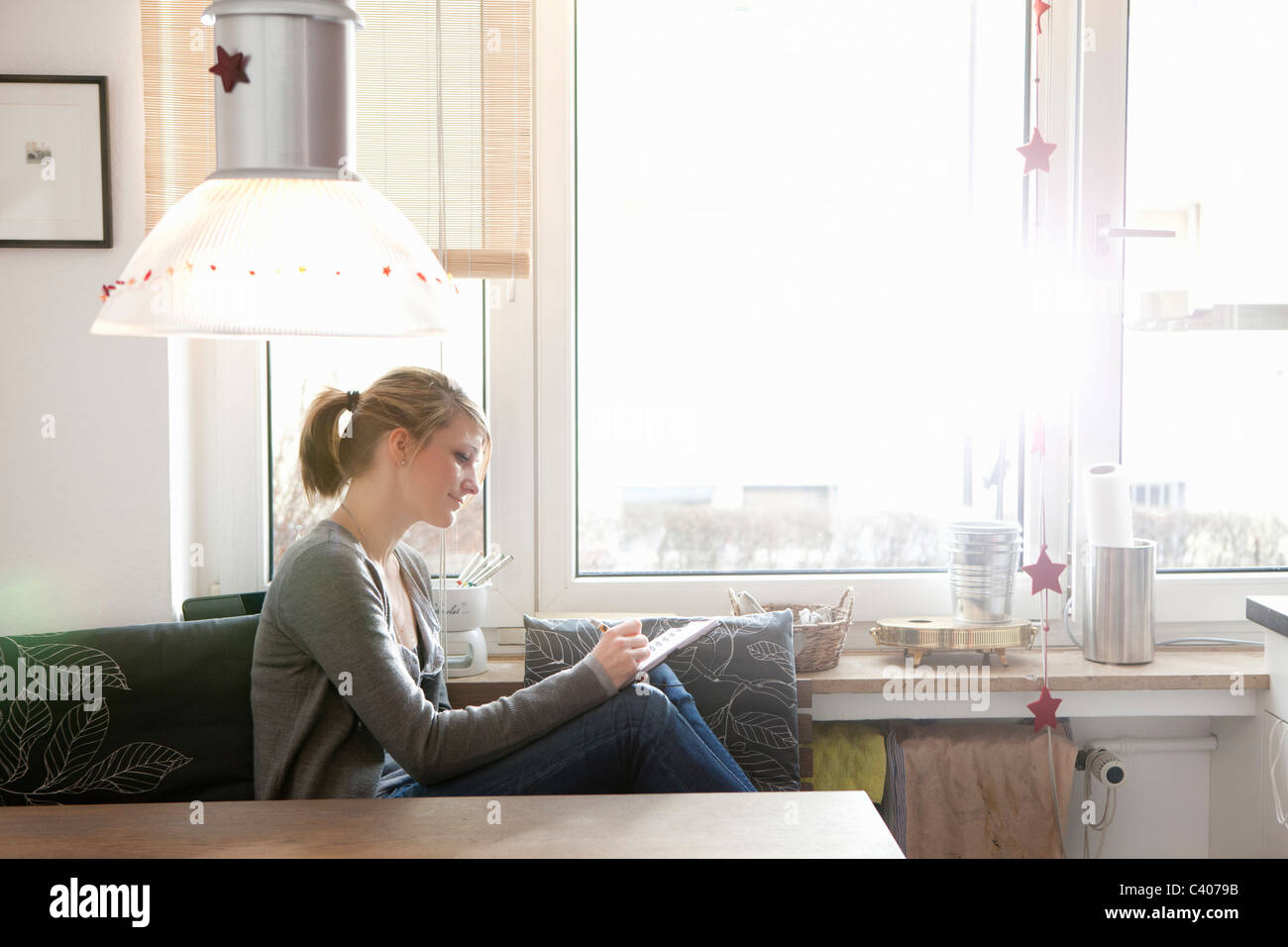 Adult writing journal kitchen table hi-res stock photography and images ...