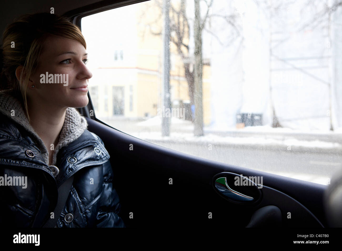 Woman looking out of car window Stock Photo - Alamy