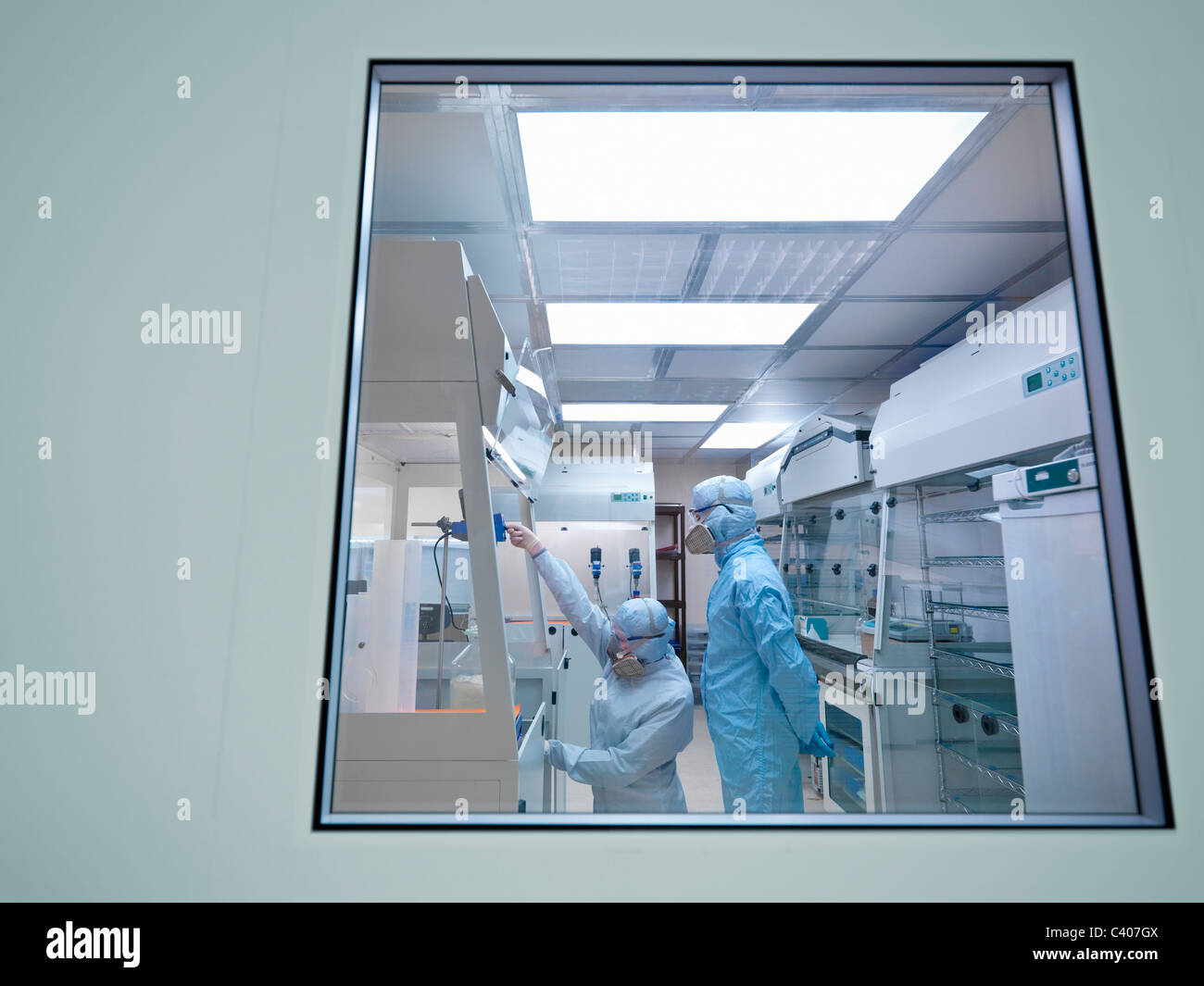 Scientists in laboratory clean room Stock Photo - Alamy