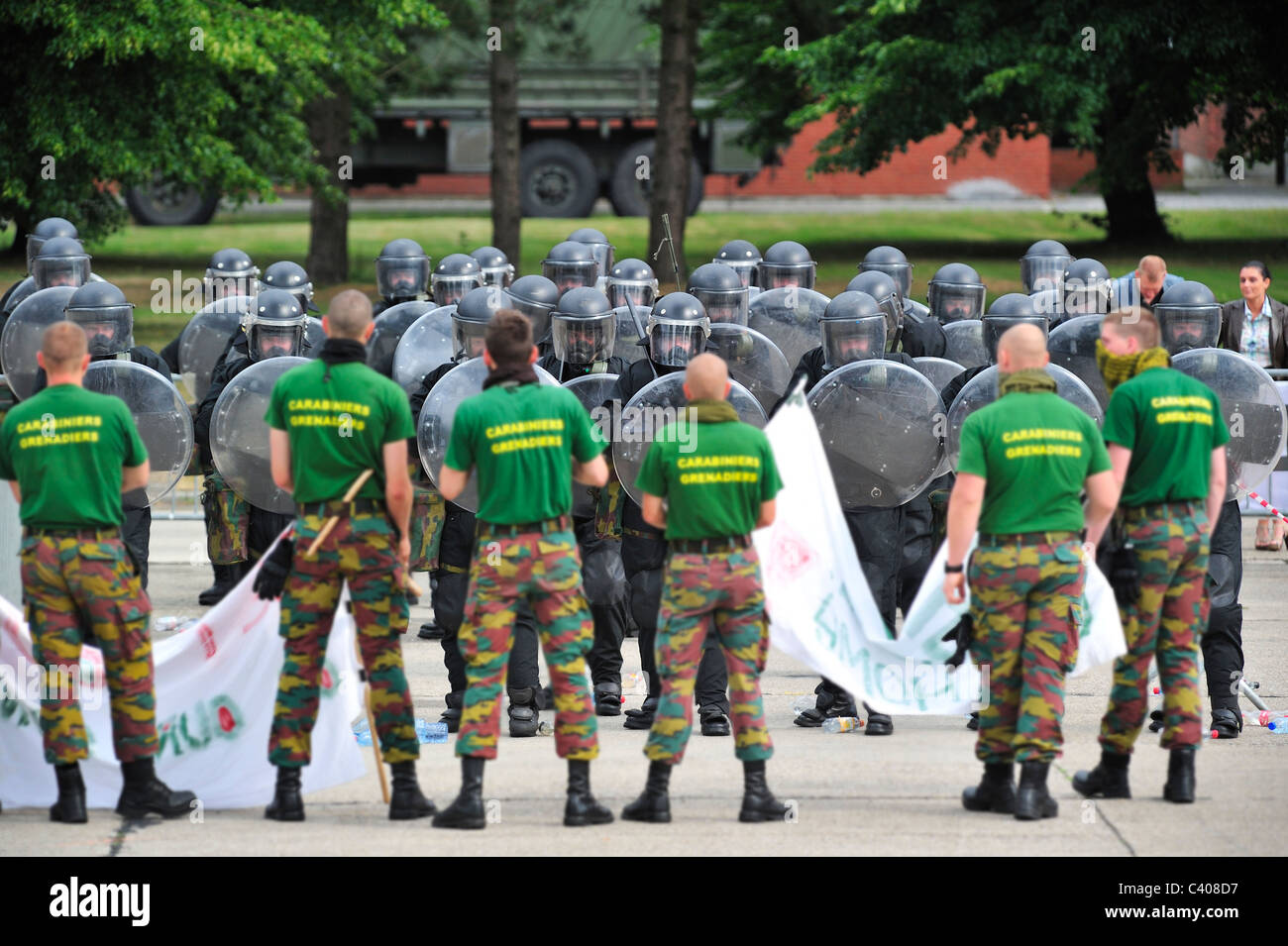 Demonstration of riot squad forming a protective barrier with riot ...