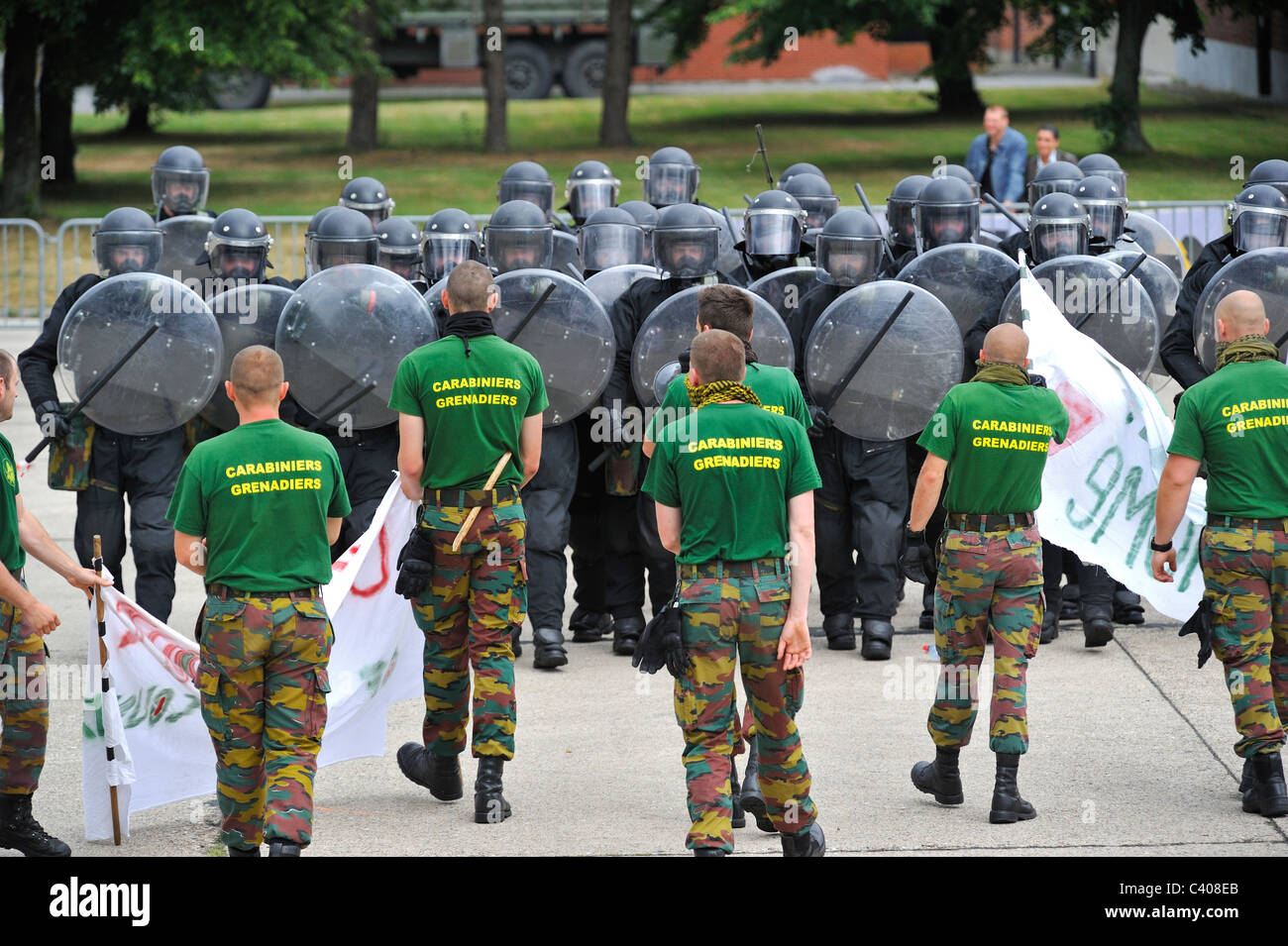 Demonstration of riot squad forming a protective barrier with riot ...