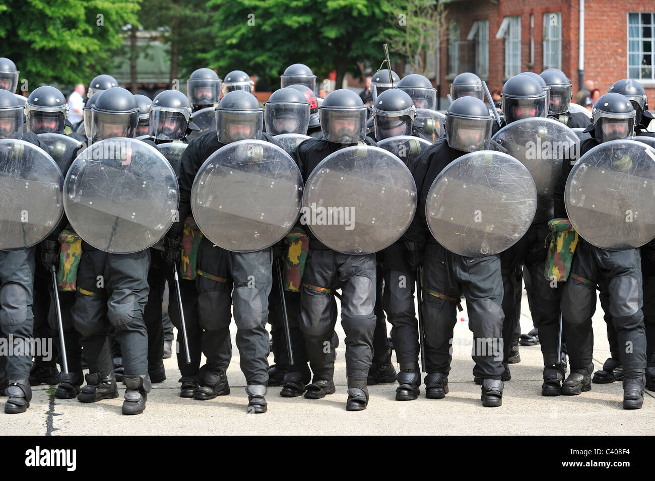 Riot squad police officers forming a protective barrier with riot Stock ...
