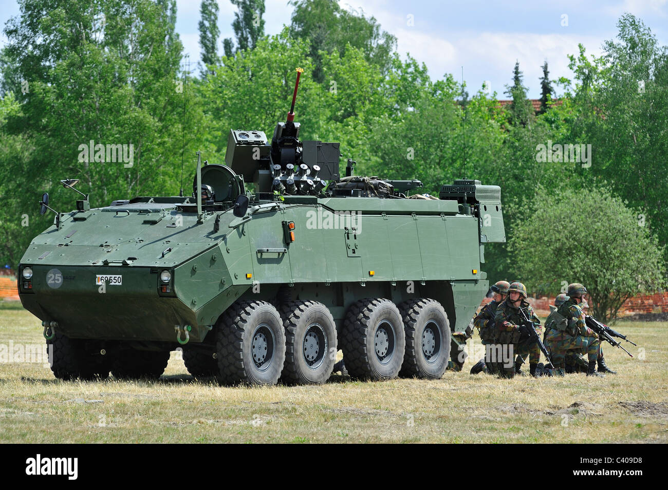 Belgian infantry soldiers firing near MOWAG Piranha IIIC armoured ...