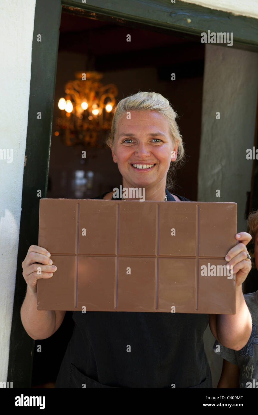 Woman showing chocolatebar Stock Photo - Alamy