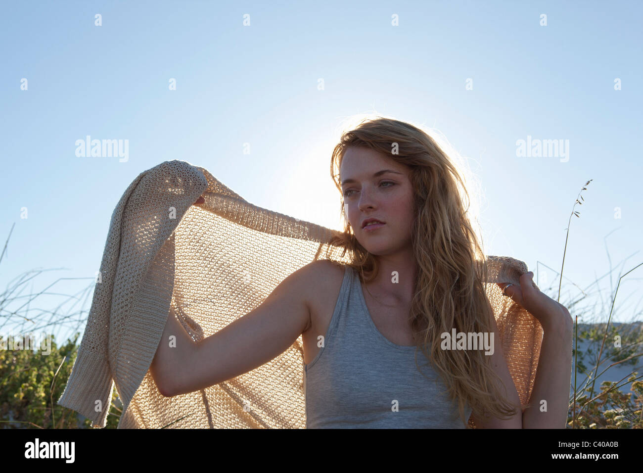 Girl lifting jacket Stock Photo - Alamy