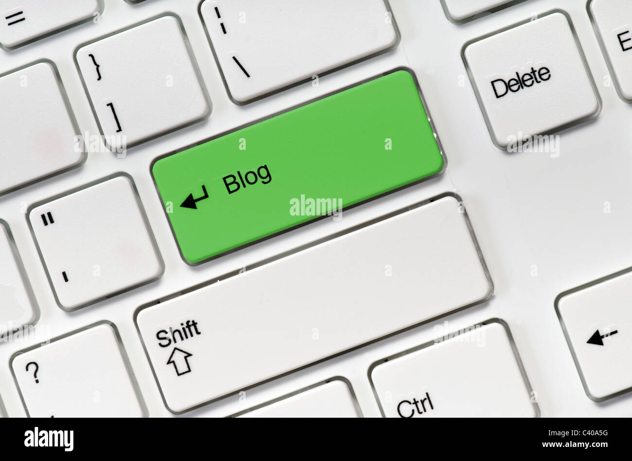 White keyboard buttons and green key blog Stock Photo - Alamy