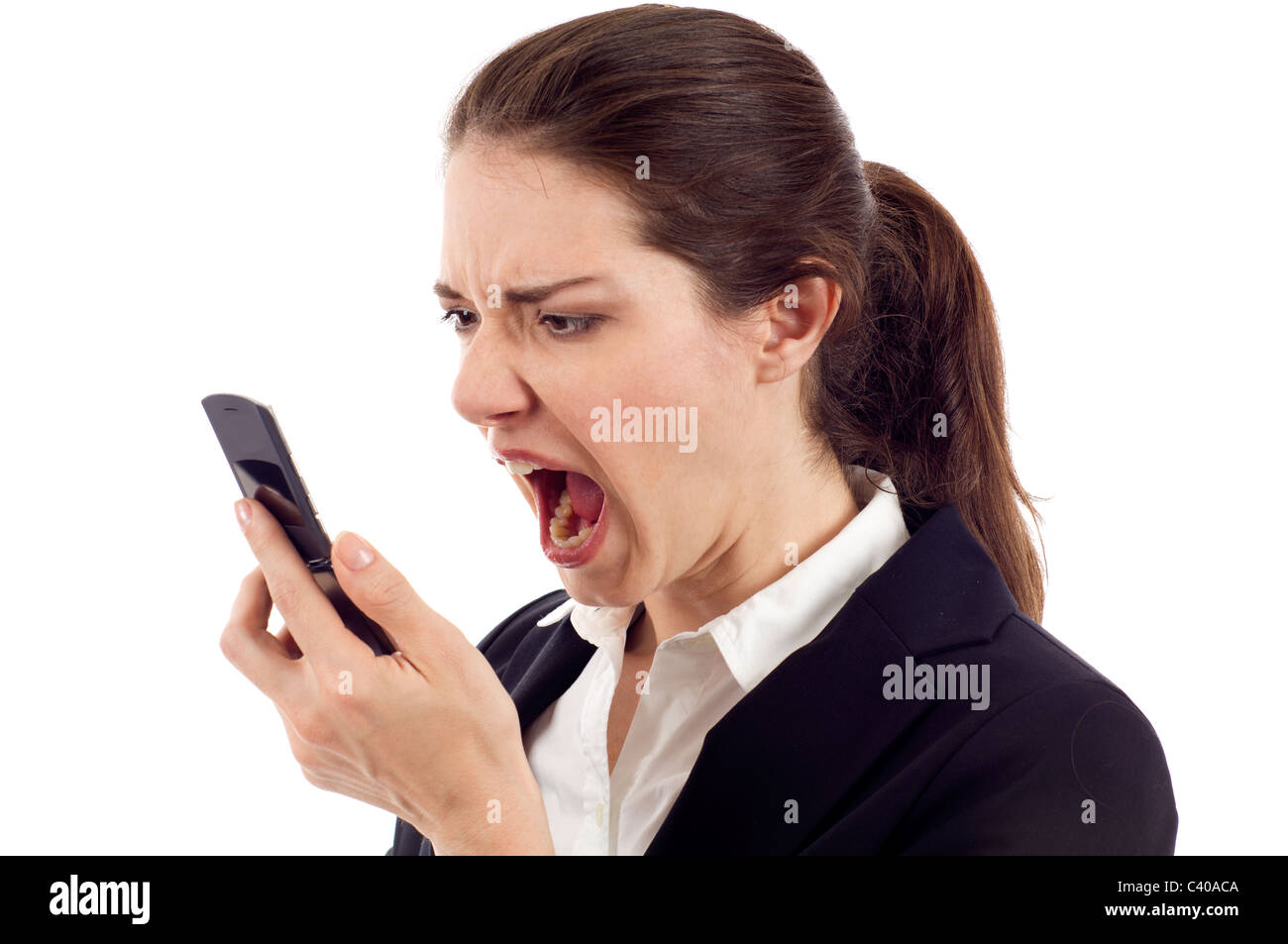 Anger - Young business woman shouting at the mobile phone isolated over ...