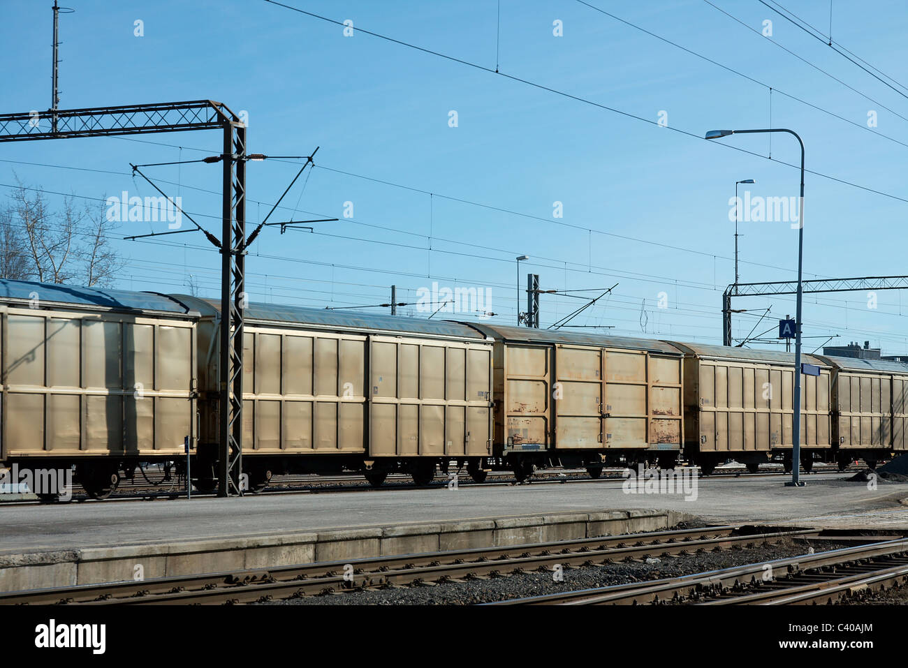 Freight train at a station Stock Photo - Alamy