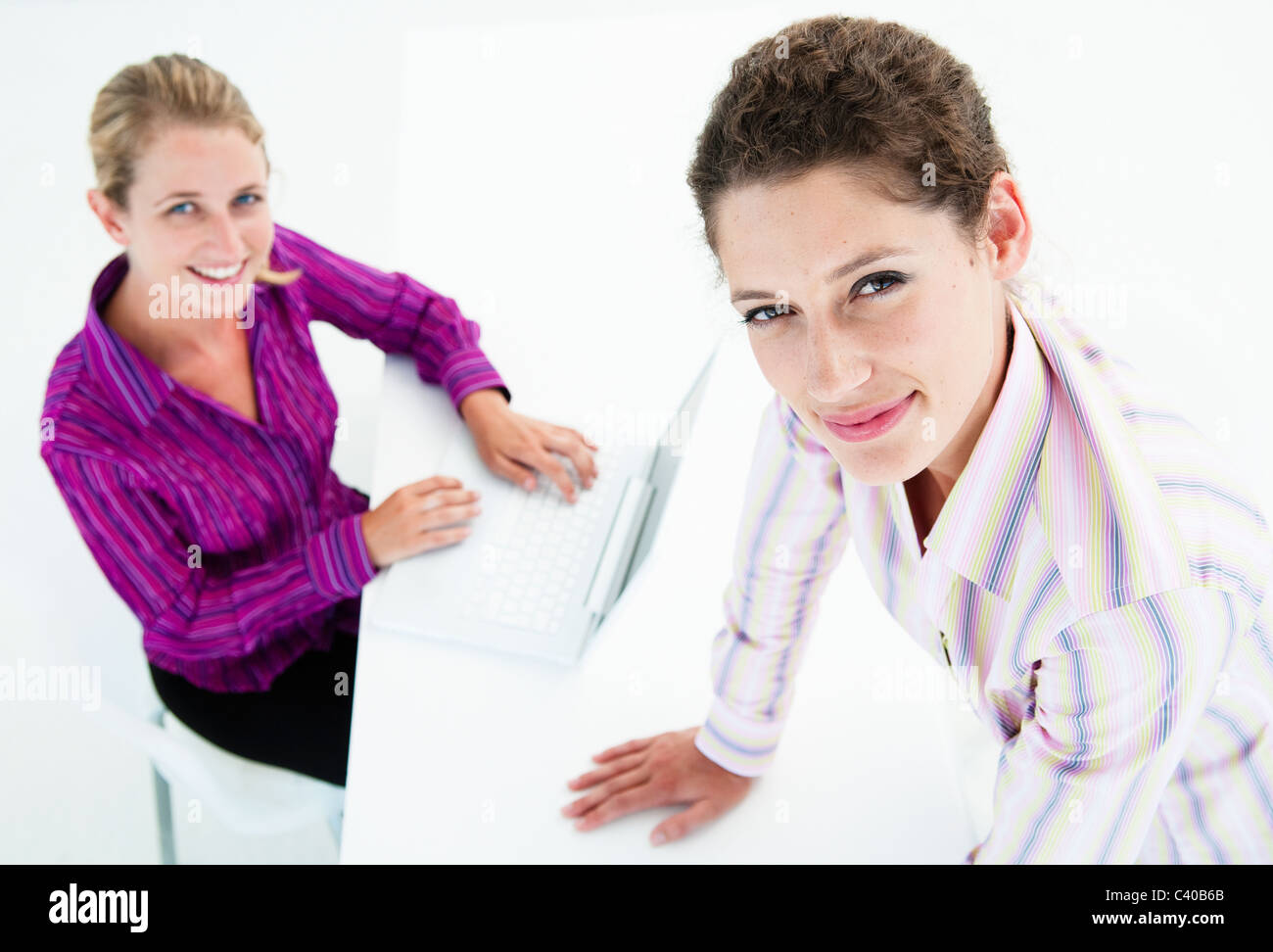 Two confident business women look up Stock Photo - Alamy