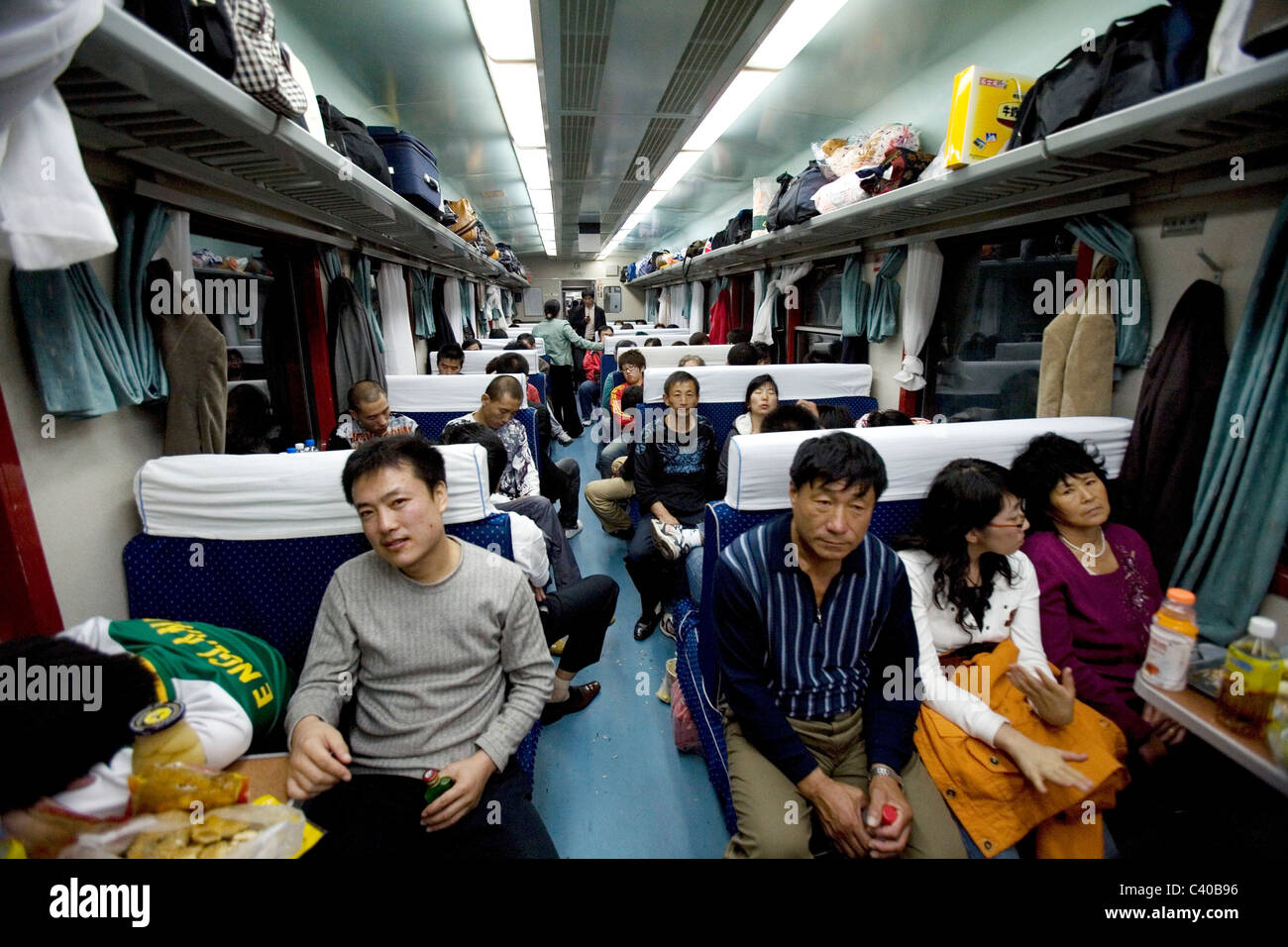 Chinese people traveling on a crowded train from Beijing to Dandong ...