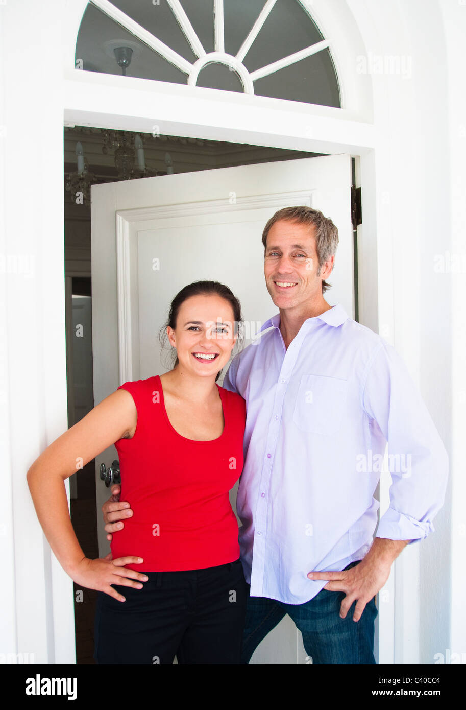 Couple outside their home Stock Photo - Alamy