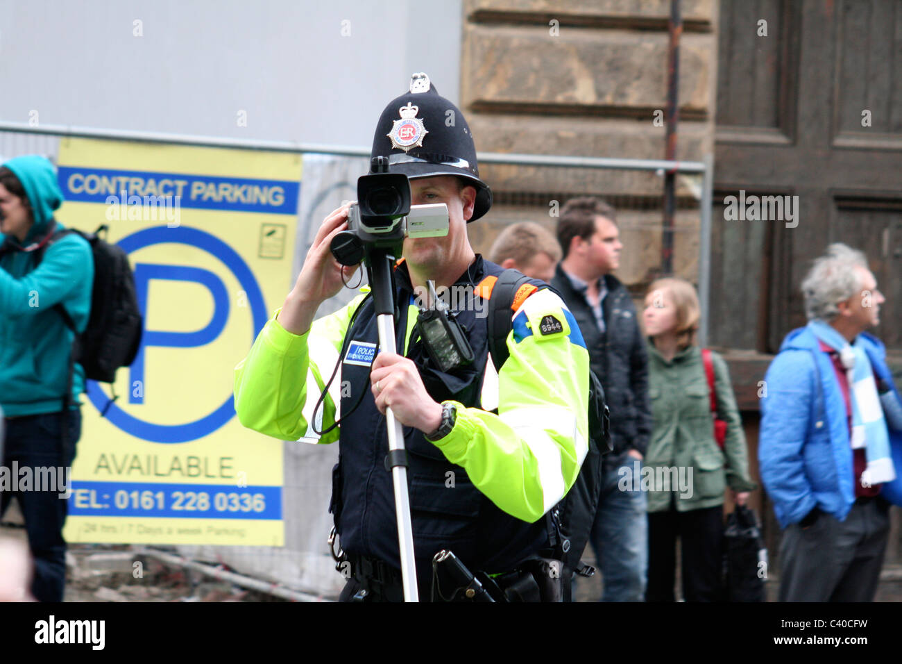 Policeman filming crowd hi-res stock photography and images - Alamy