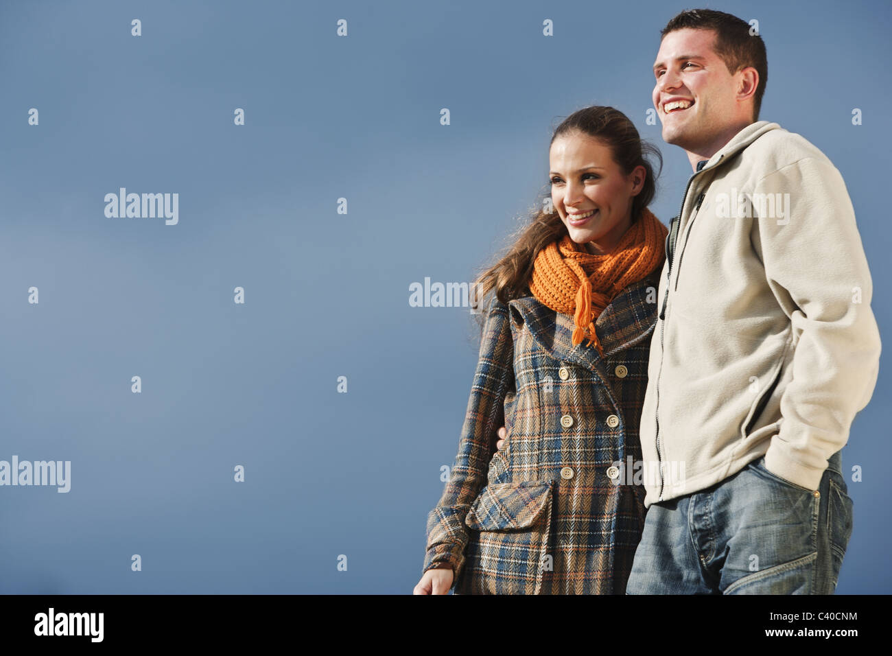 Young couple smiling while hugging Stock Photo - Alamy