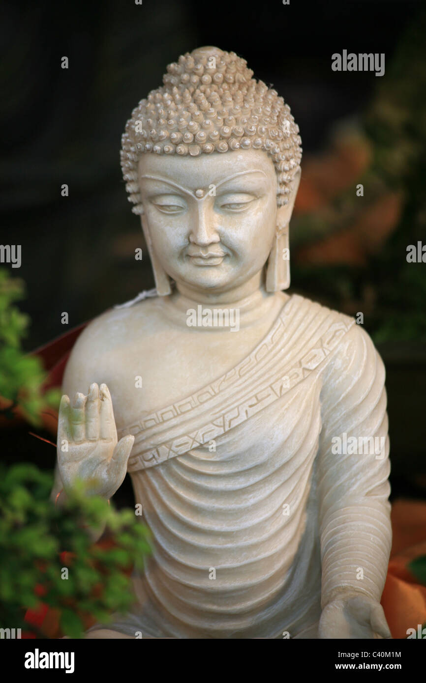 Small Buddha figurine in the garden Stock Photo - Alamy