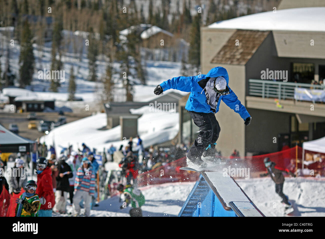 Snowboarder competes in a 'rail jam' near base facilities at Brighton ...