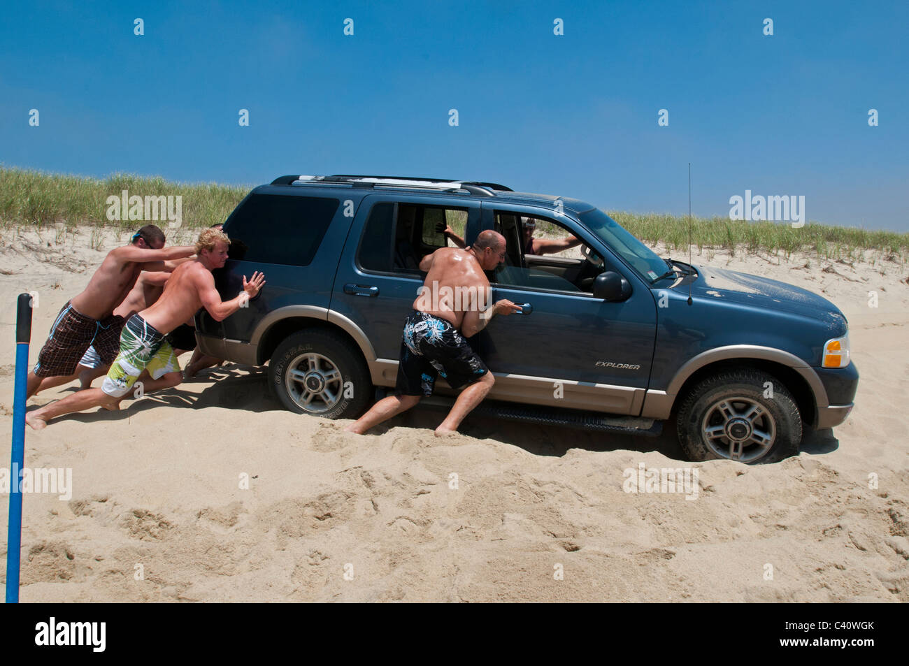 Men push a stuck truck on the beach on Nantucket Island Stock Photo - Alamy