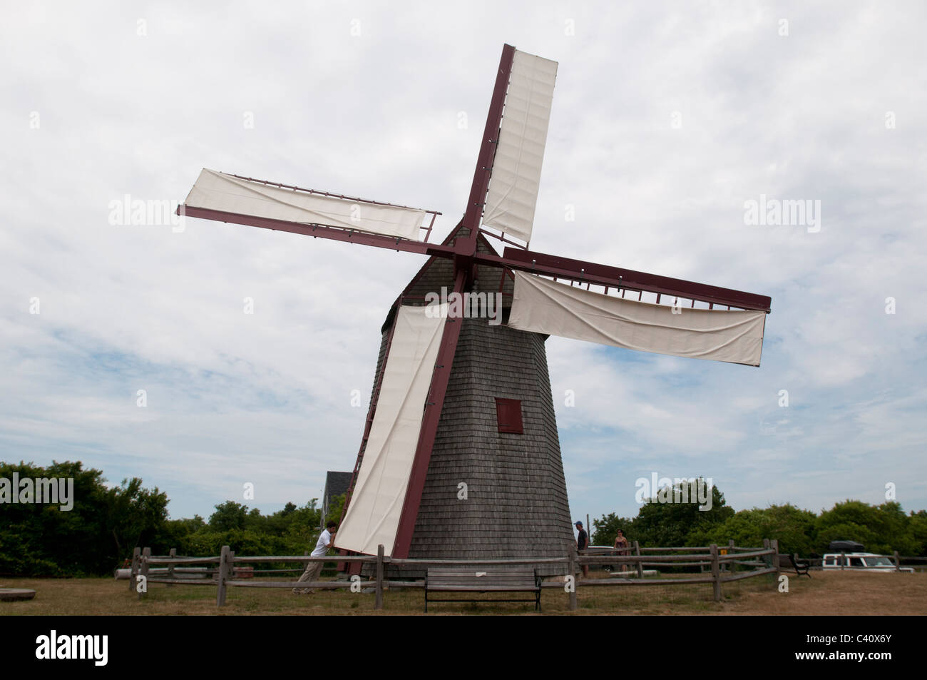 A man push starts a windmill on Nantucket Island Stock Photo - Alamy