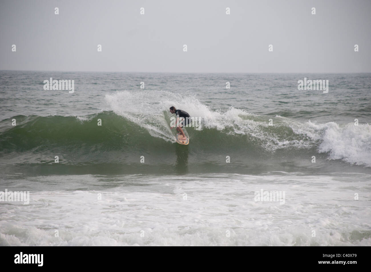 A man surfs the waves off Nobadeer Beach Stock Photo - Alamy